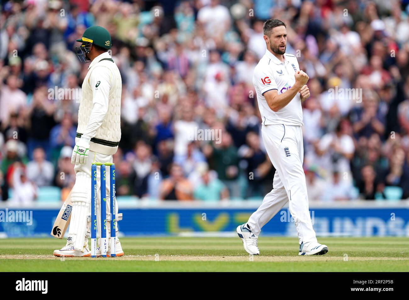 England's Chris Woakes (right) celebrates the wicket of Australia's ...