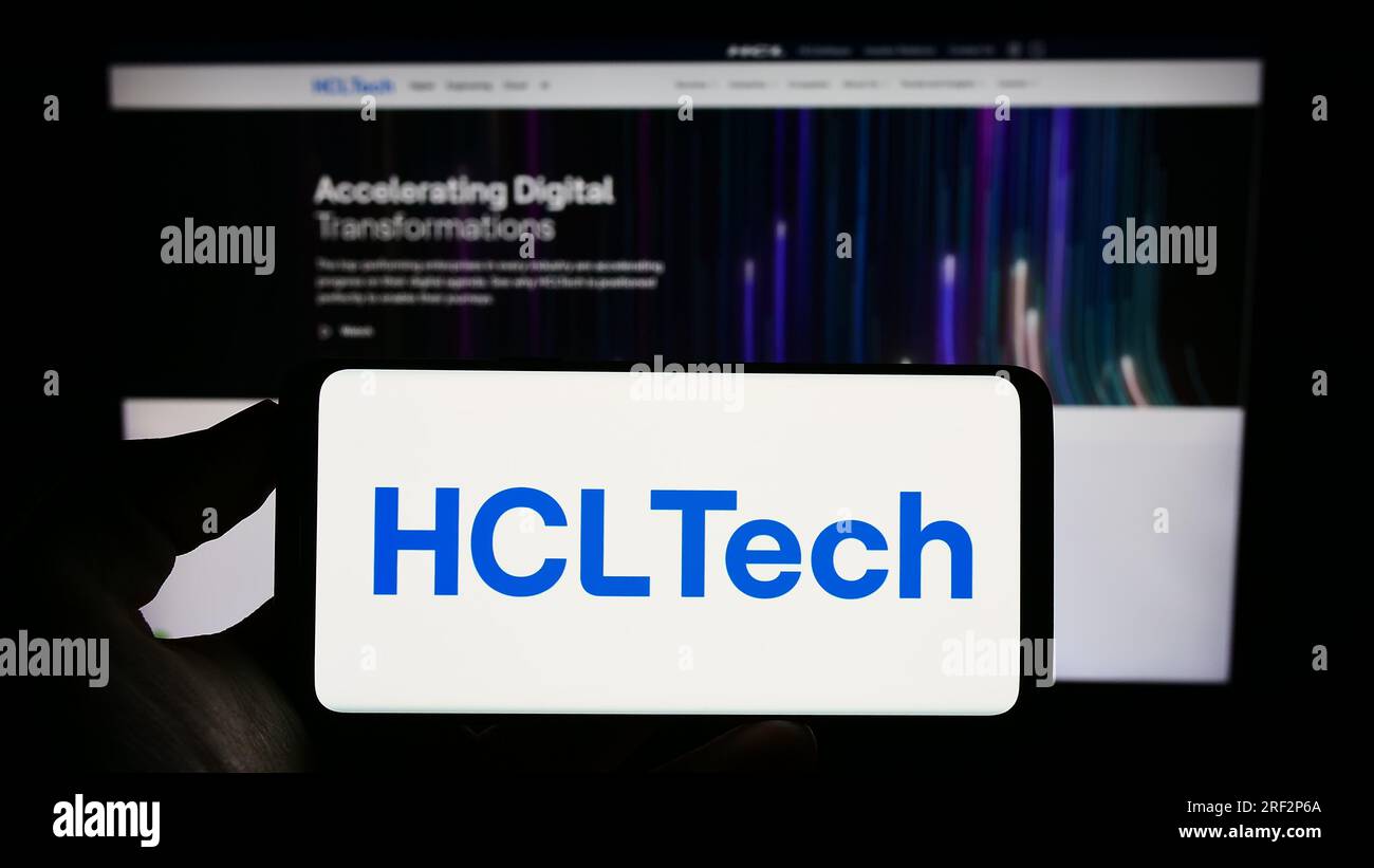 Person holding mobile phone with logo of Indian company HCL ...