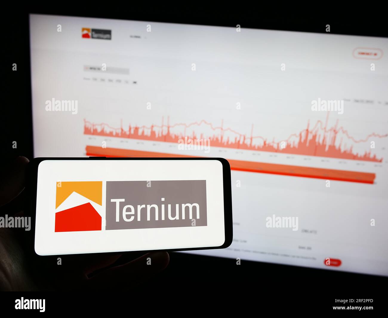 Person holding mobile phone with logo of steel company Ternium S.A. on ...
