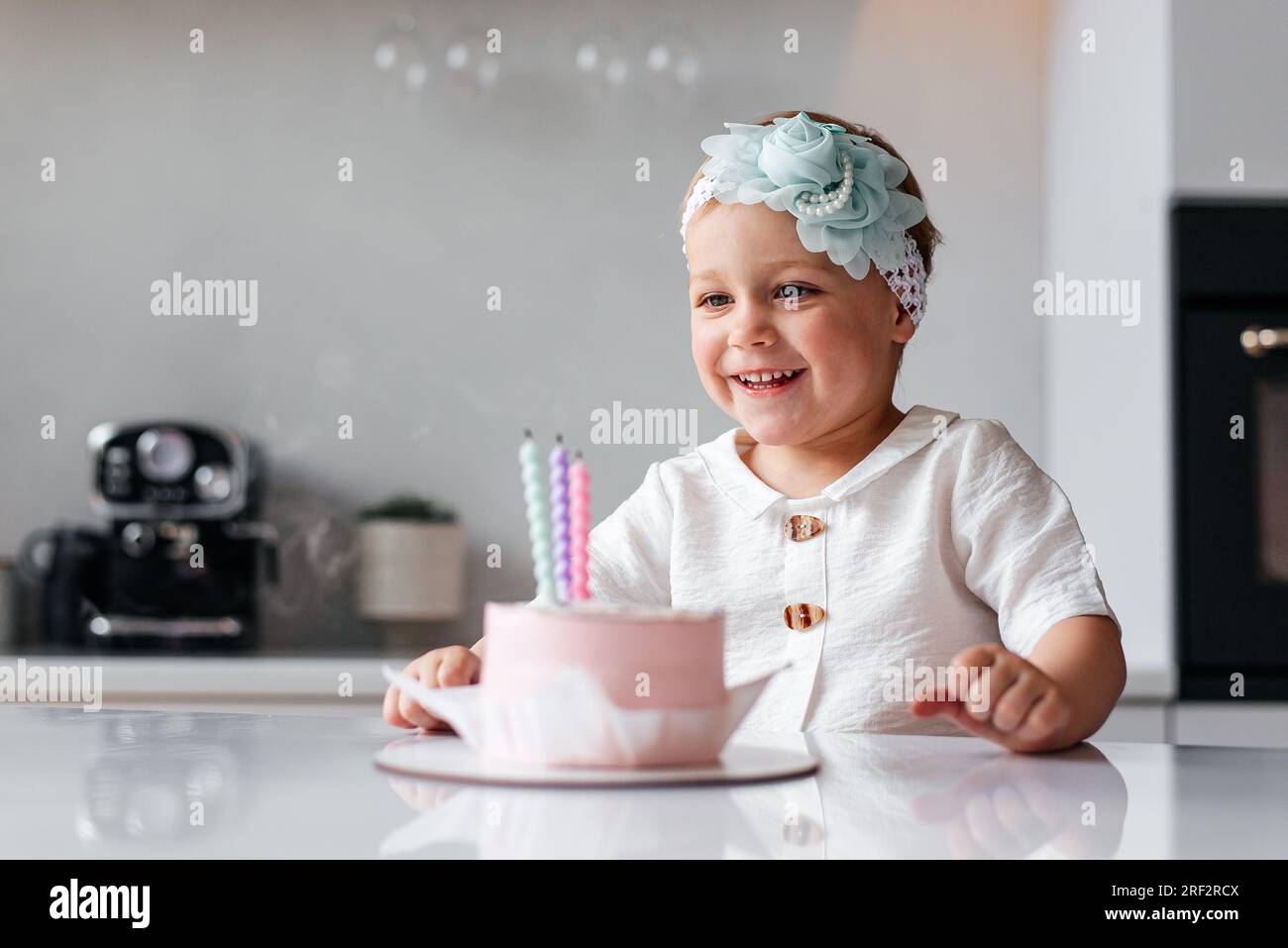 Adorable three year old kid celebrating his birthday and blowing ...