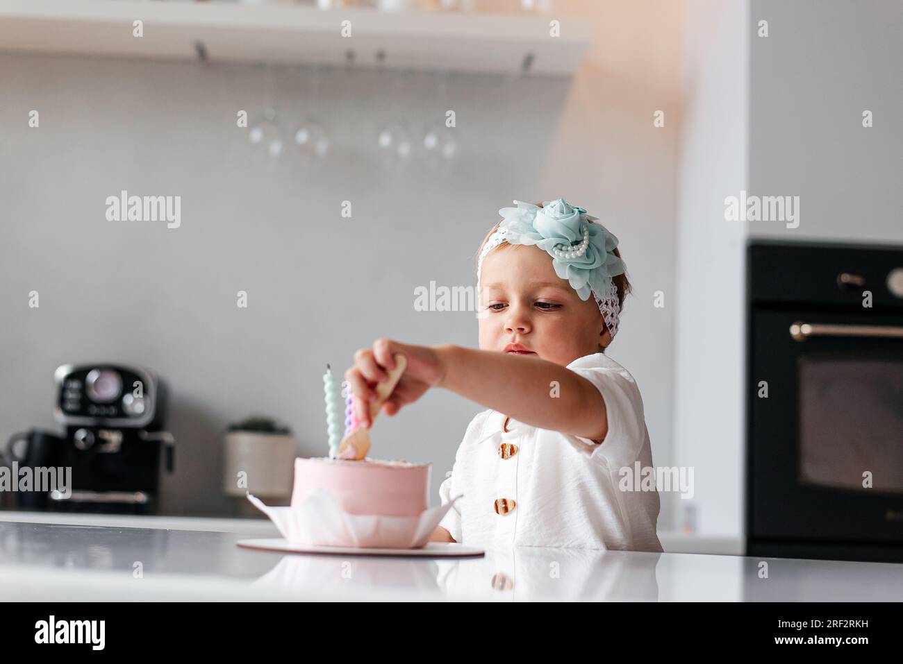 Adorable three year old kid celebrating his birthday and blowing ...