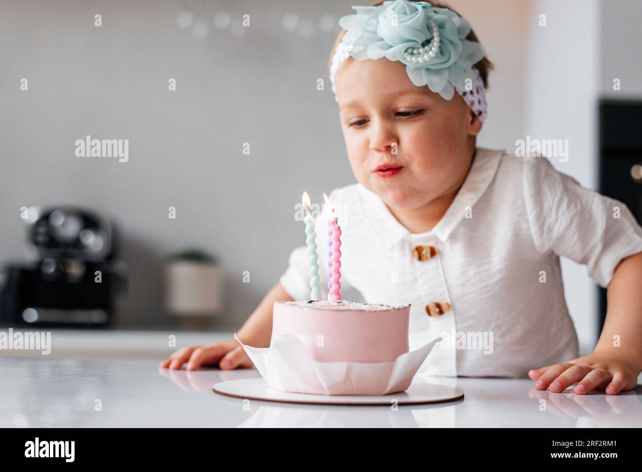 Adorable three year old kid celebrating his birthday and blowing ...