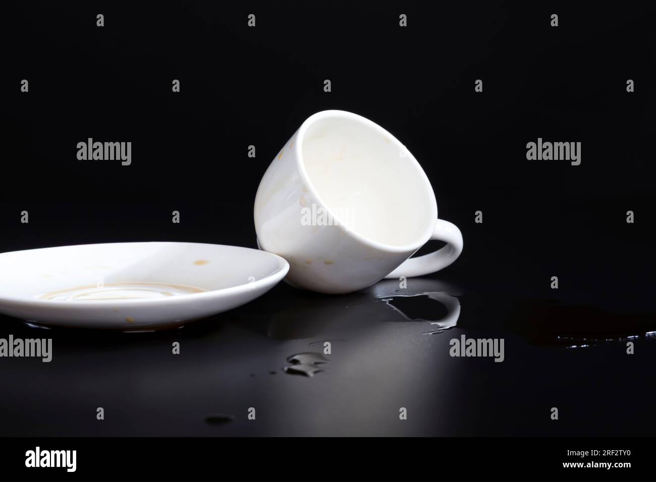 black aromatic coffee spilled due to carelessness, close up of glass ...