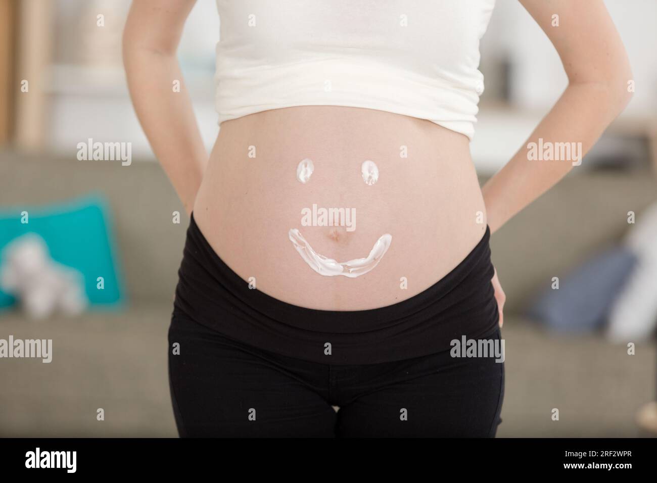 pregnant woman with a smily face on the belly Stock Photo - Alamy