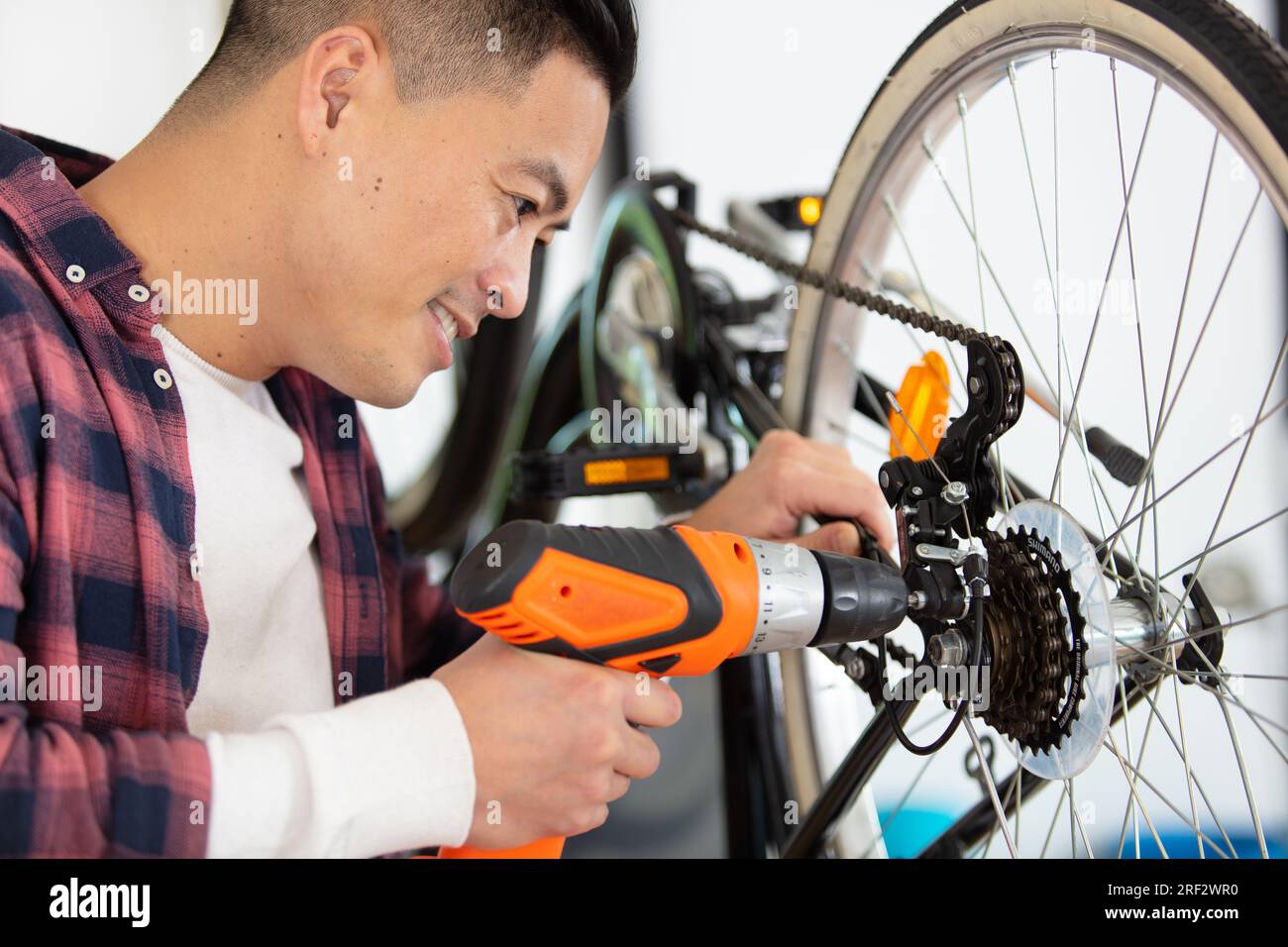 bicycle mechanic working on wheel with cordless screwdriver Stock Photo ...
