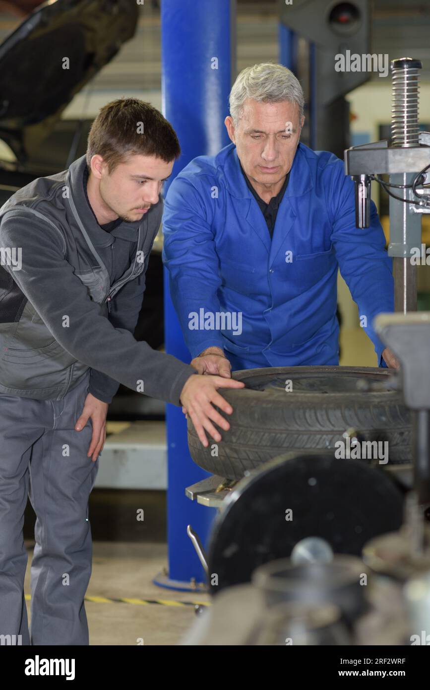 student with instructor repairing a car during apprenticeship Stock Photo - Alamy