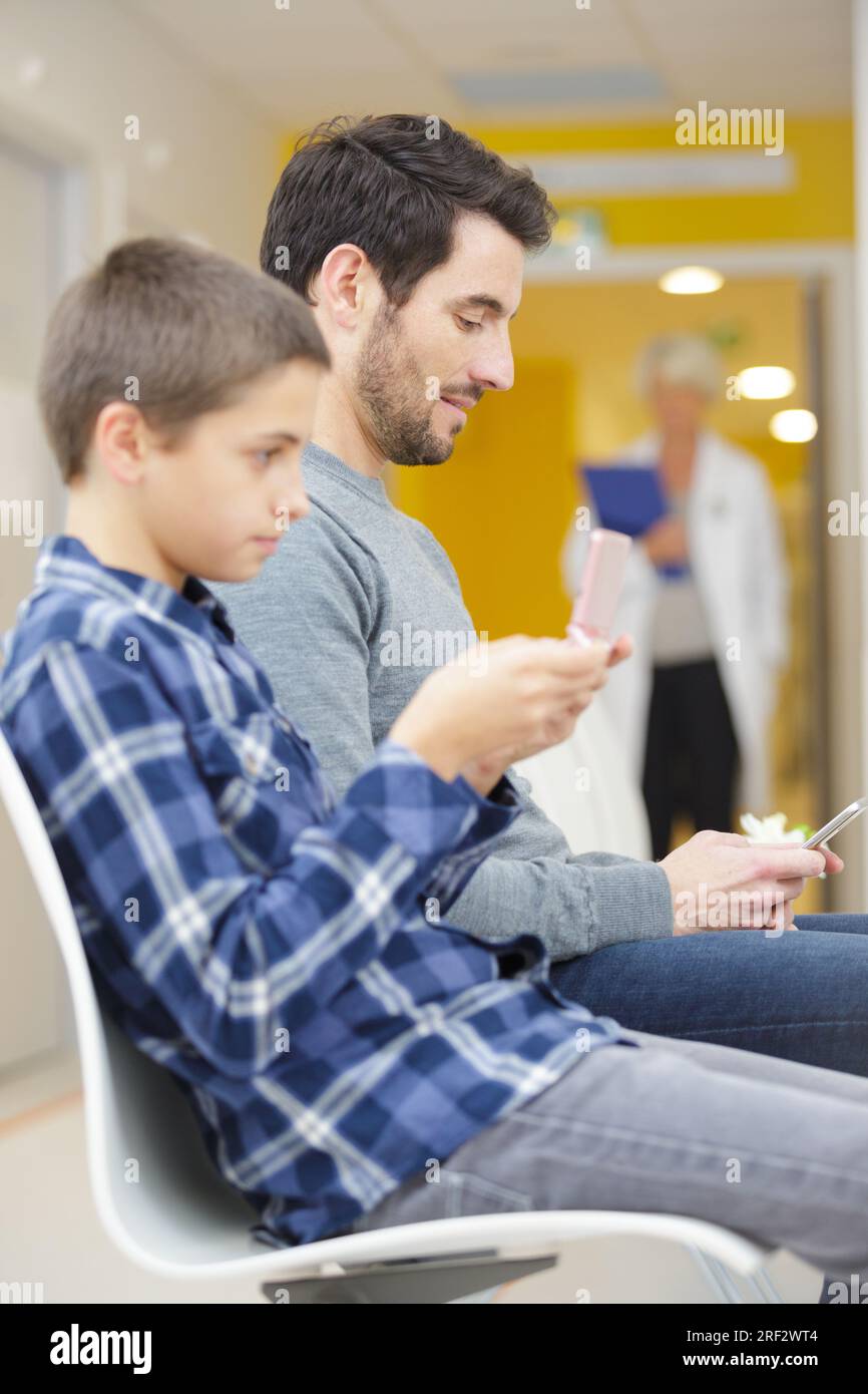 father and son waiting at the hospital Stock Photo - Alamy