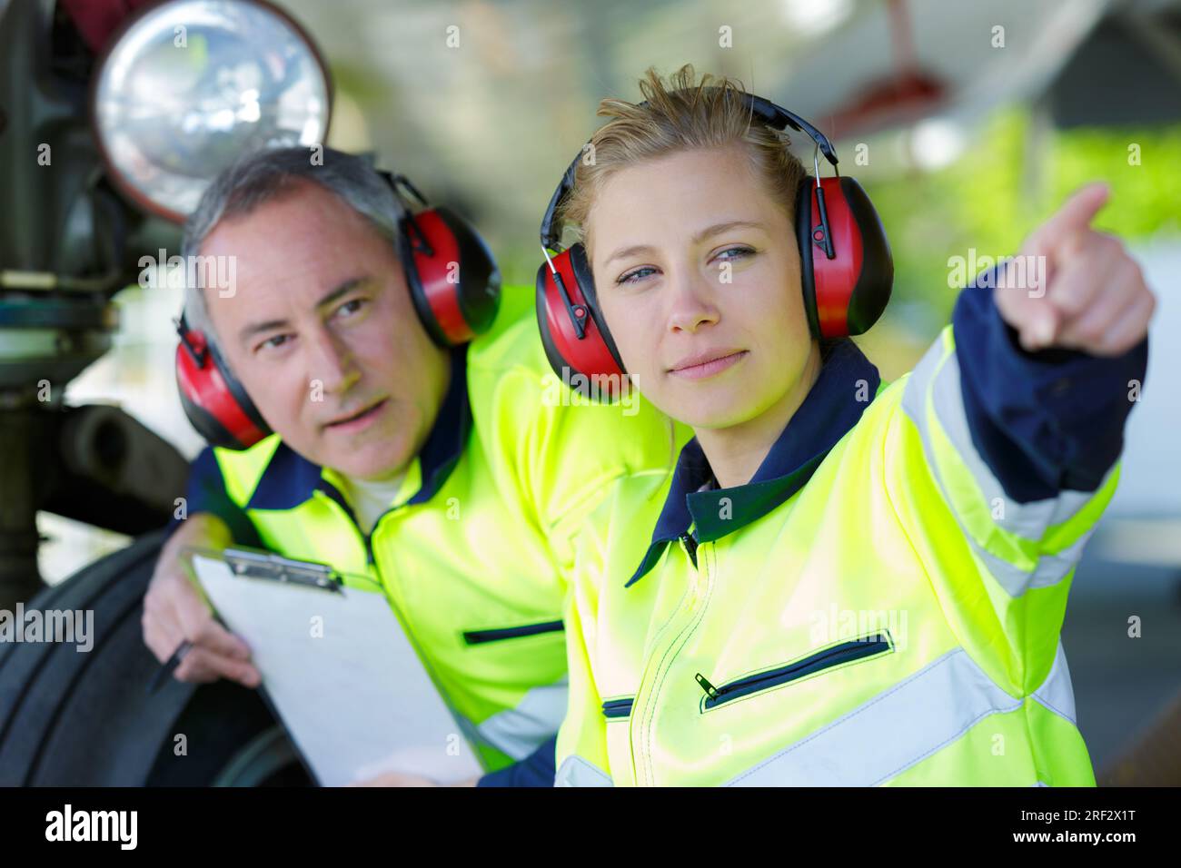 airport staff pointing at distance Stock Photo - Alamy