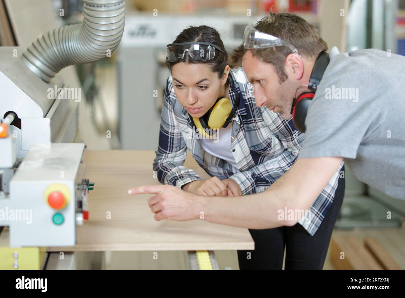 female carpenter working with wood machine Stock Photo - Alamy