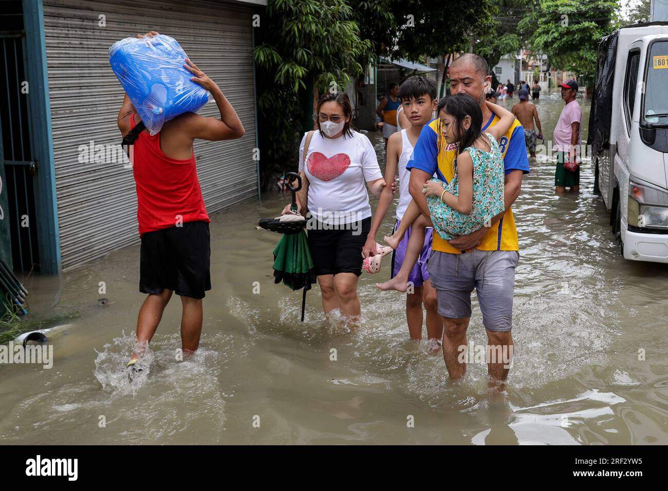 Calumpit, Bulacan, Philippines. 31st July, 2023. People wade through a ...