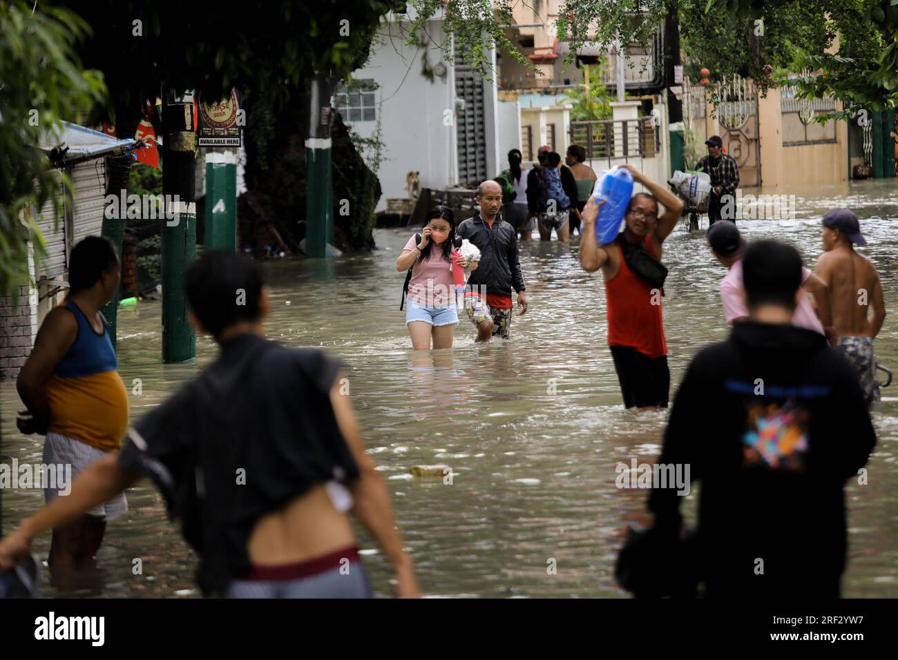 Calumpit, Bulacan, Philippines. 31st July, 2023. People wade through a ...