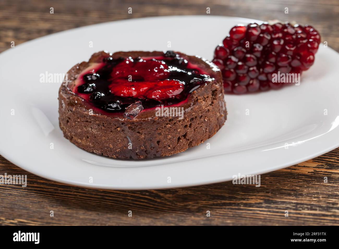 round tartlet with strawberries and blueberries in butter cream, baked ...