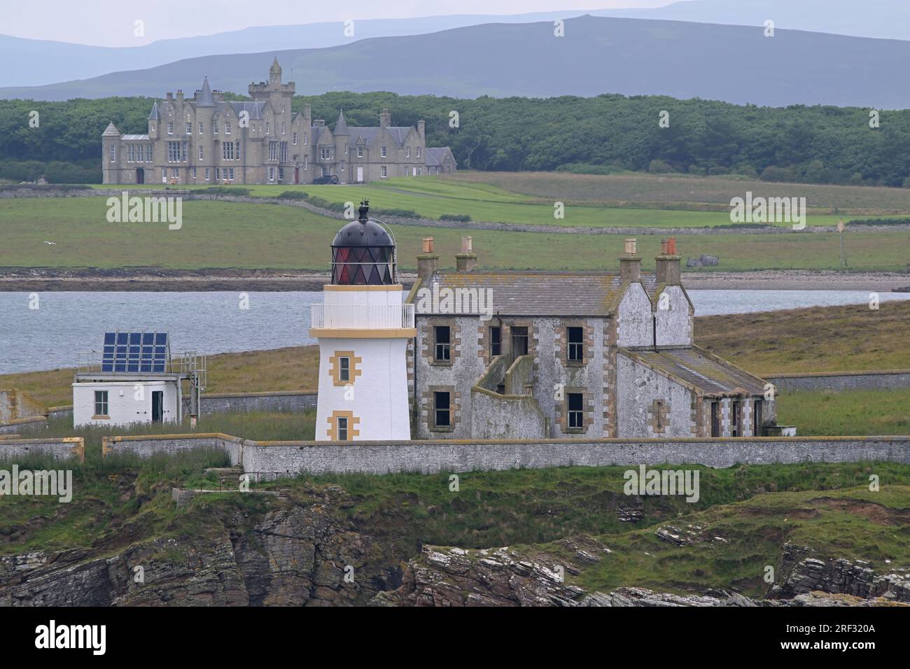 Helliar Holm Lighthouse with Balfour Castle in the distance Scotland ...