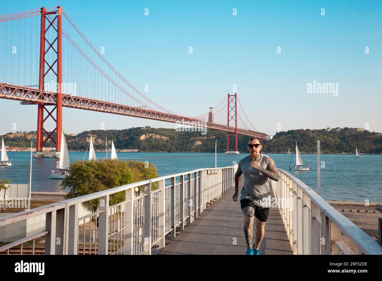Man running across the bridge in front of a beautiful city landscape ...