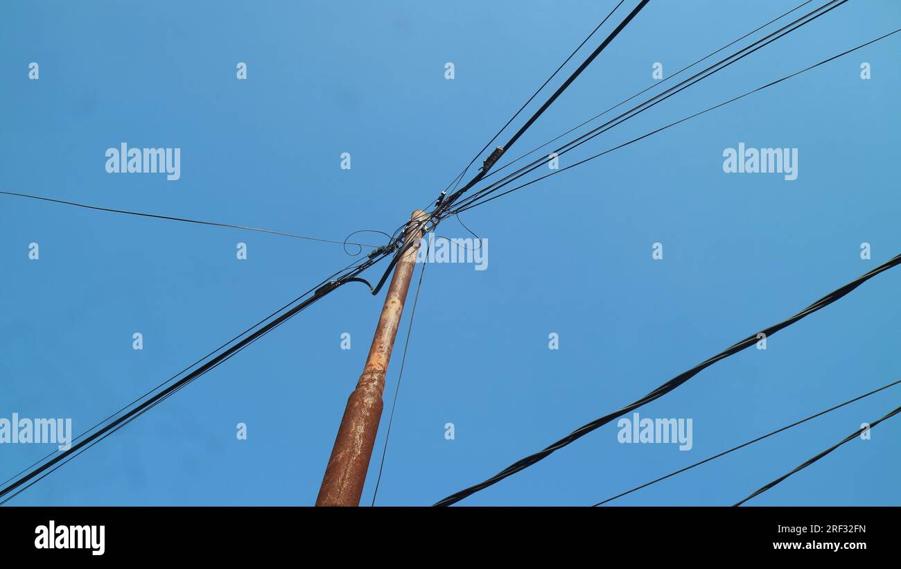 Electric poles and cables seen from below against the sky Stock Photo ...
