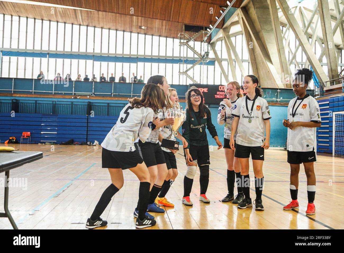 Girls playing football at a futsal tournament Stock Photo - Alamy
