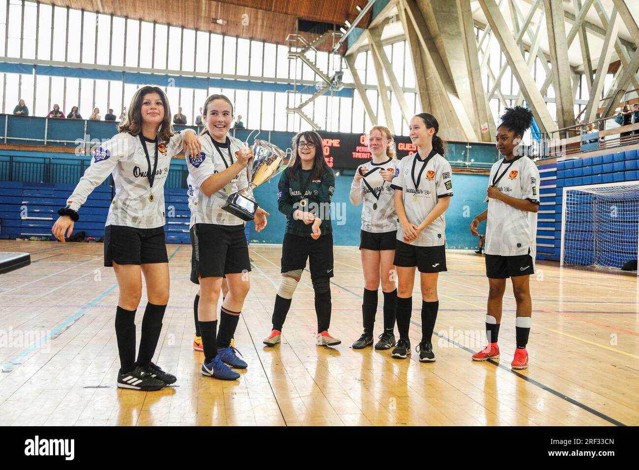 Girls playing football at a futsal tournament Stock Photo - Alamy