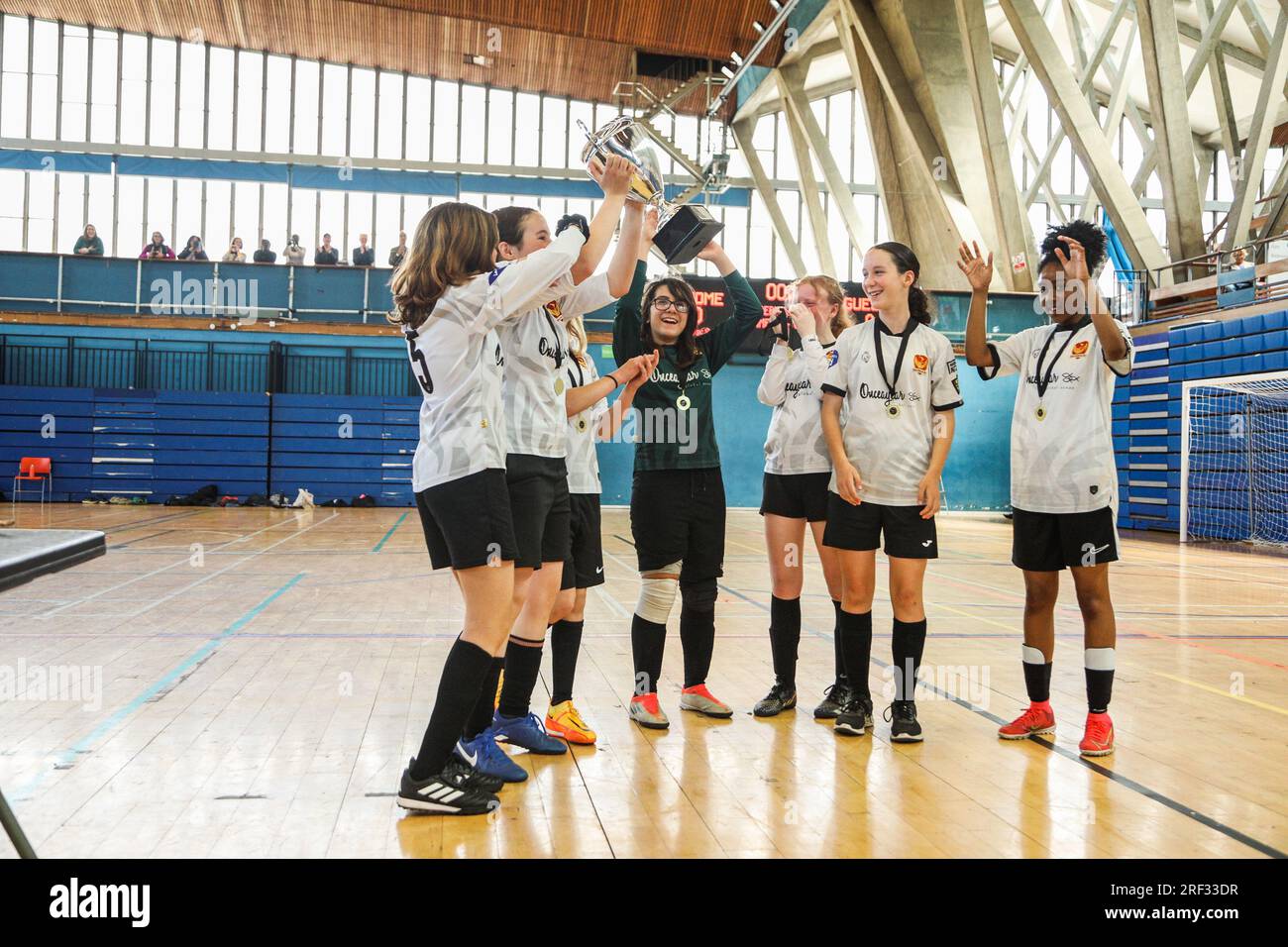 Girls playing football at a futsal tournament Stock Photo - Alamy