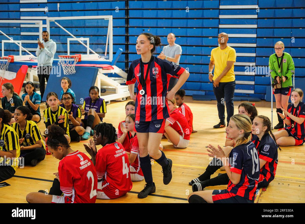 Girls playing football at a futsal tournament Stock Photo - Alamy
