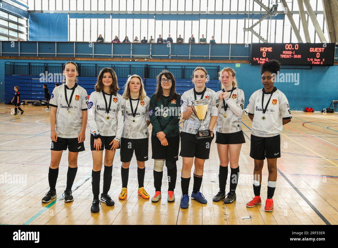 Girls playing football at a futsal tournament Stock Photo - Alamy