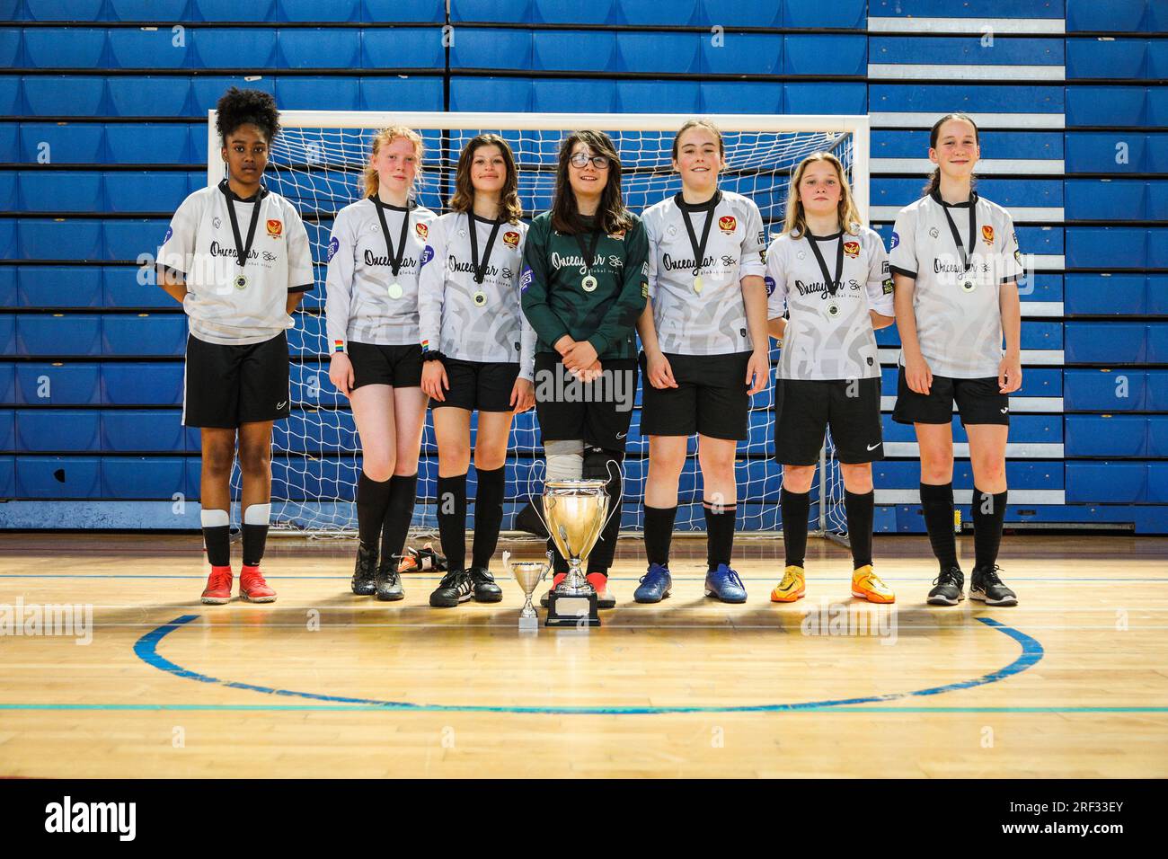 Girls playing football at a futsal tournament Stock Photo - Alamy
