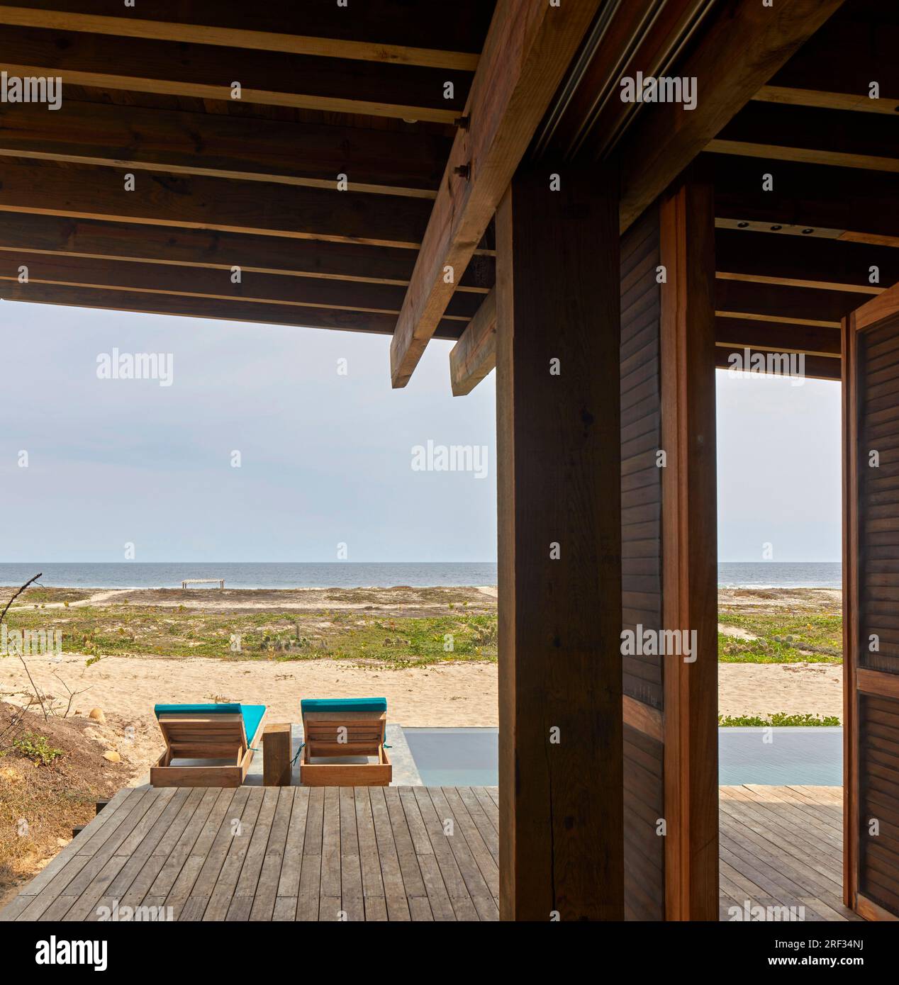Timber deck with view from pool to ocean. Punta Pajaros, Oaxaca, Mexico ...