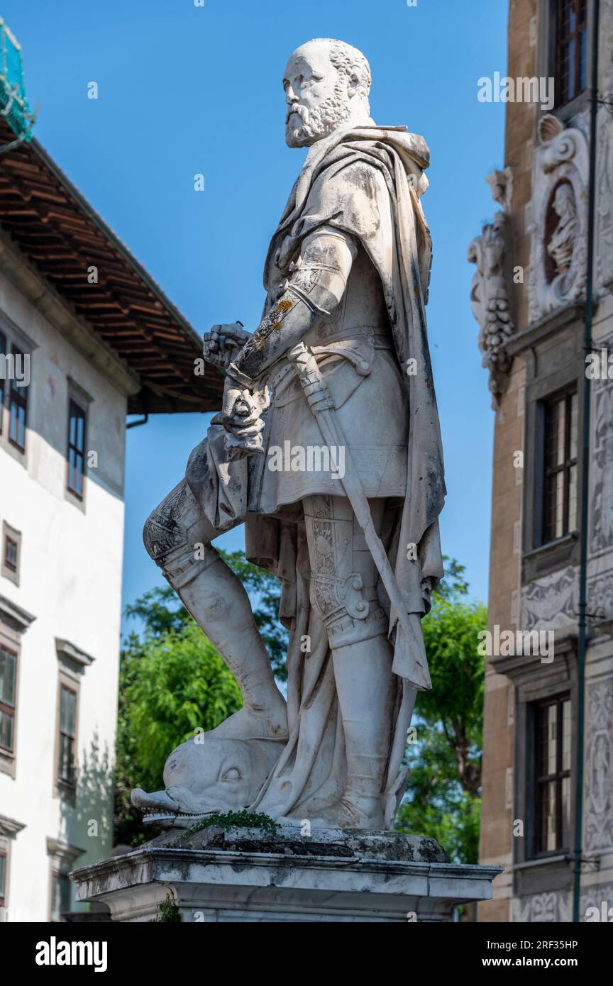 A statue of Cosimo I de Medici, standing on a high pedestal in front of ...