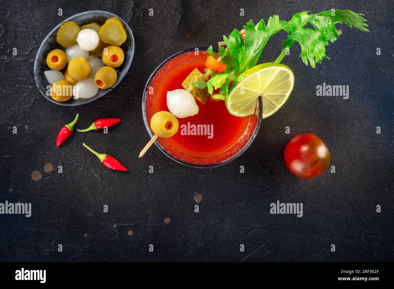 Bloody Mary cocktail with garnish on a black background, shot from the ...
