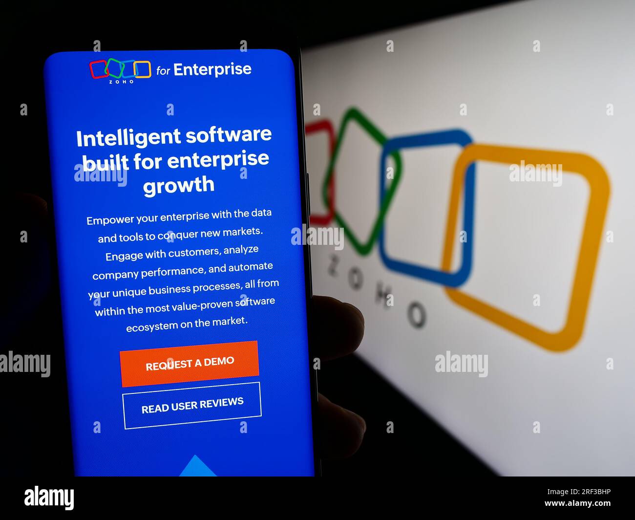 Person holding mobile phone with web page of Indian technology company ...
