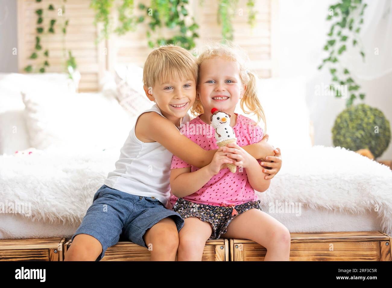 Cute sweet toddler children, tickling feet on the bed, laughing and ...