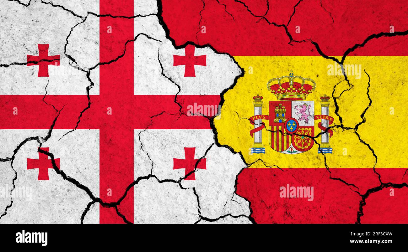 Flags of Georgia and Spain on cracked surface - politics, relationship ...