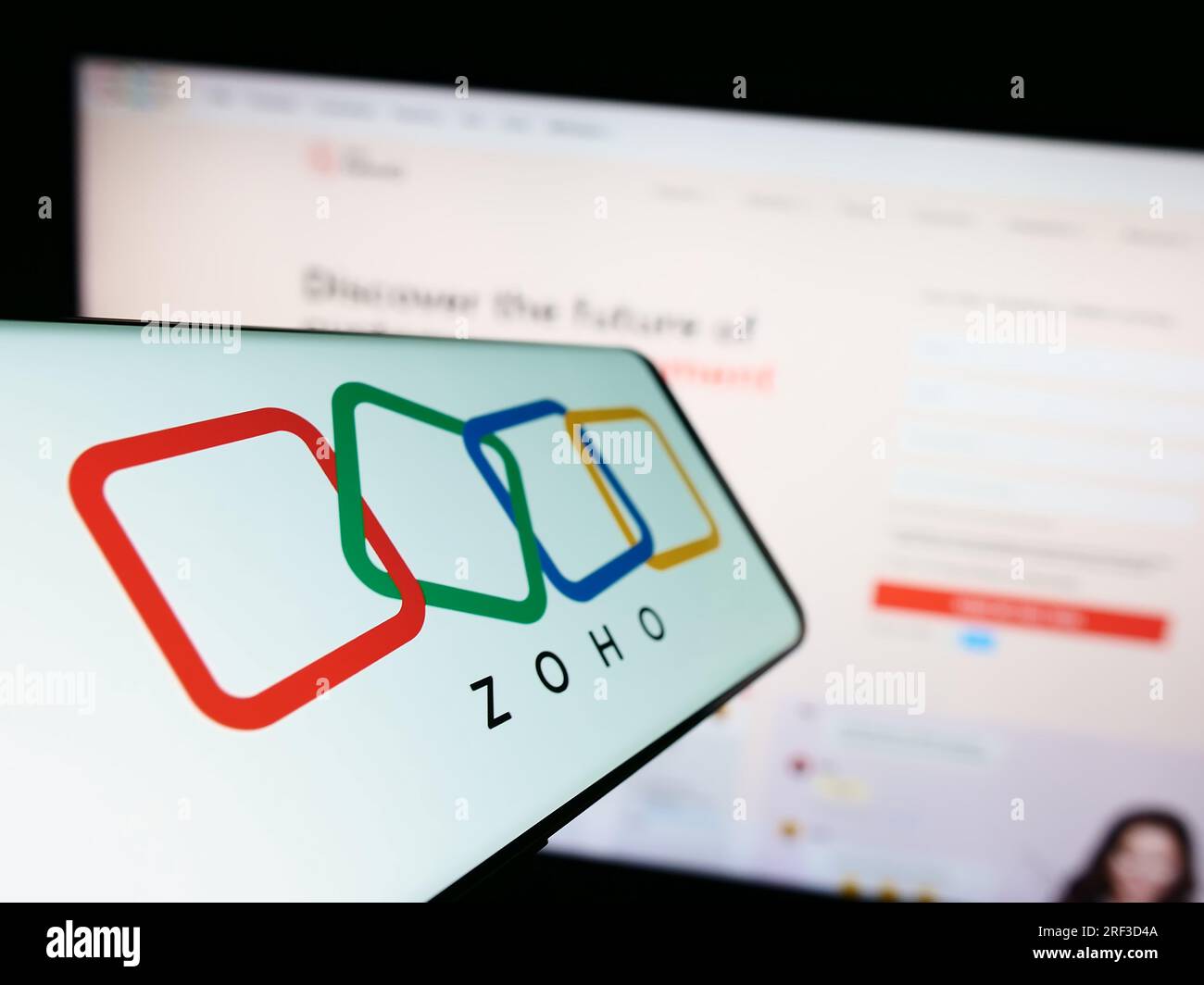 Mobile phone with logo of Indian technology company Zoho Corporation on ...