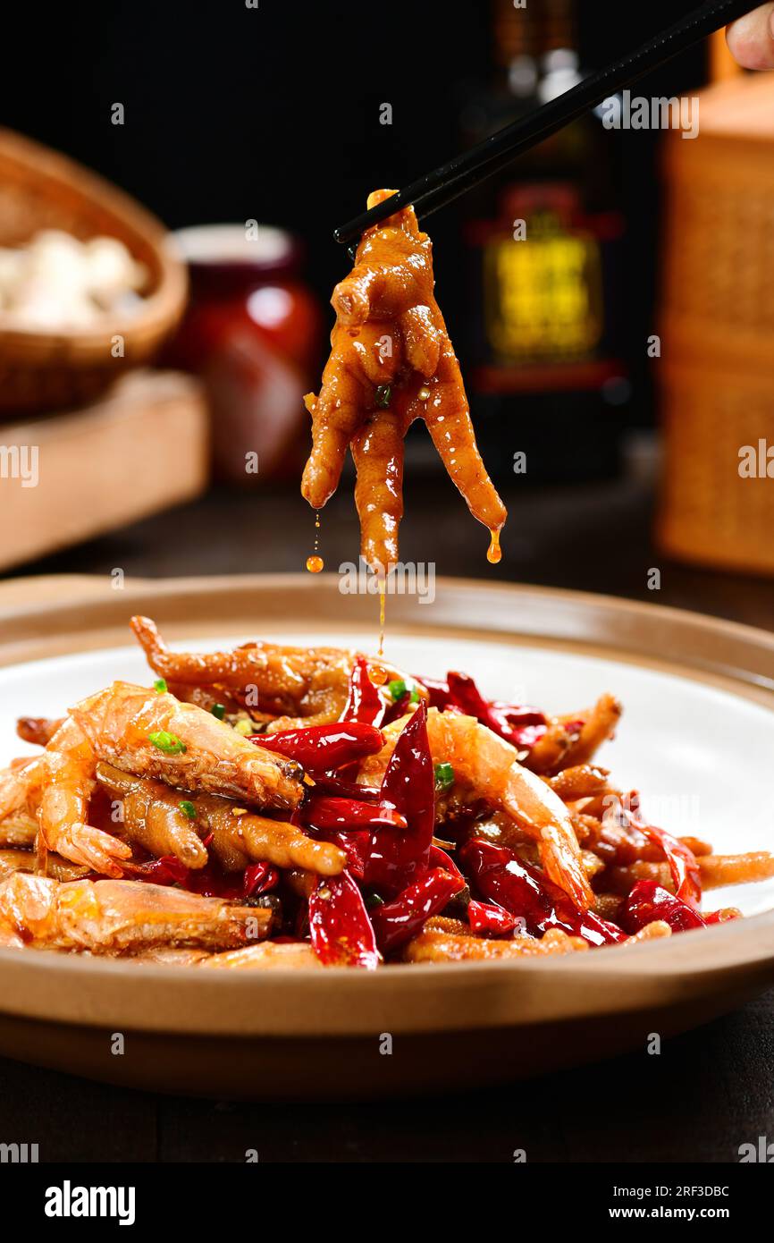 Chicken feet with hot Pepper on retro dark background.Delicious and ...