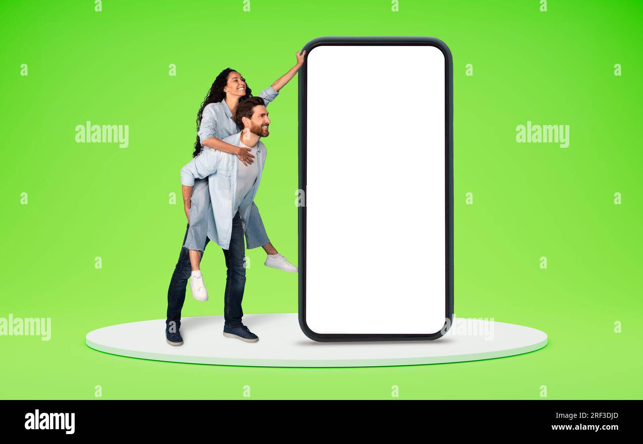 Funny couple showing great deal, phone with white screen Stock Photo ...
