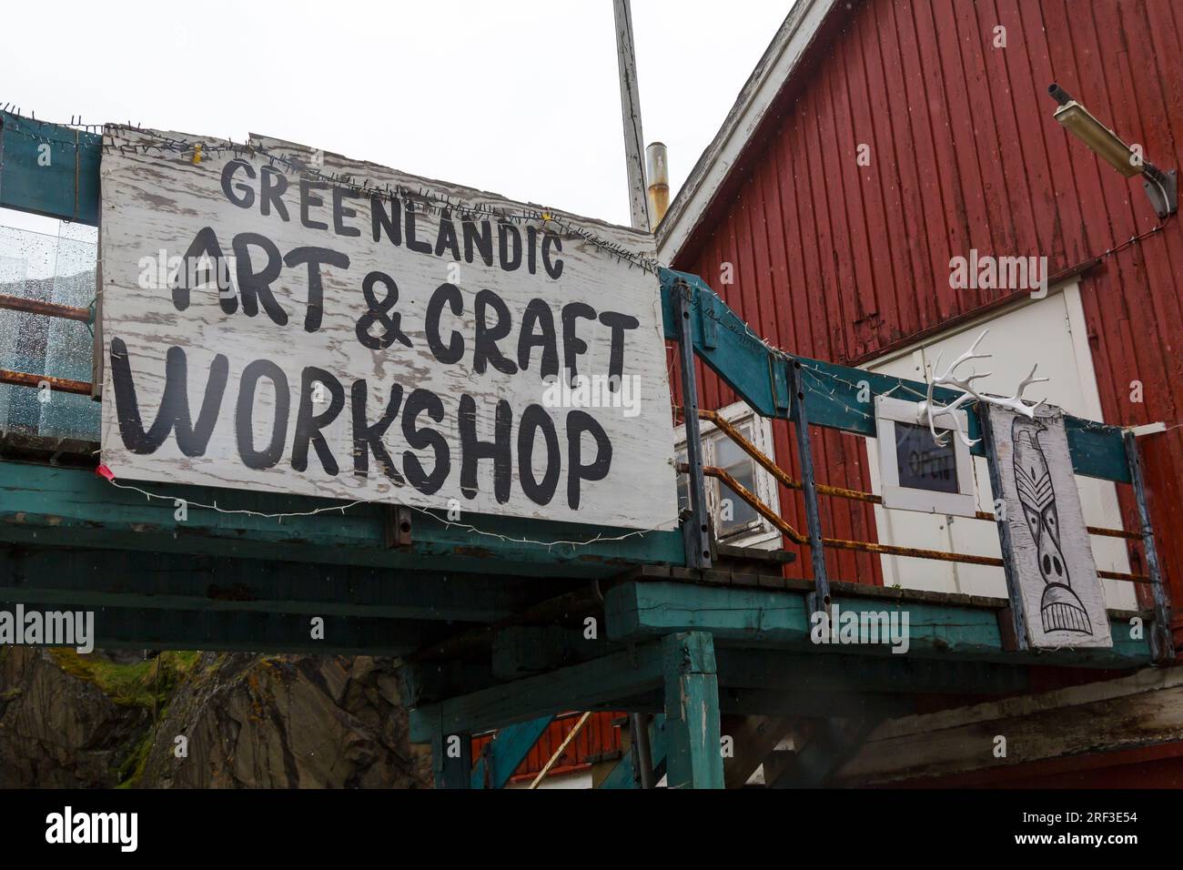 Greenlandic Art & Craft Workshop sign at Sisimiut, Greenland on a wet ...