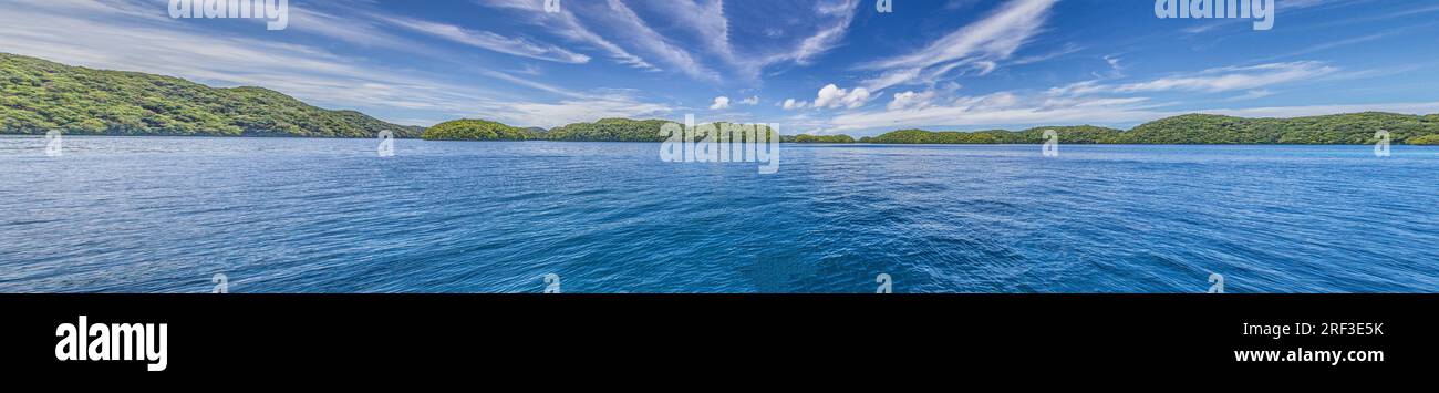 Panoramic view over turquoise blue water to a tropical island in Palau ...