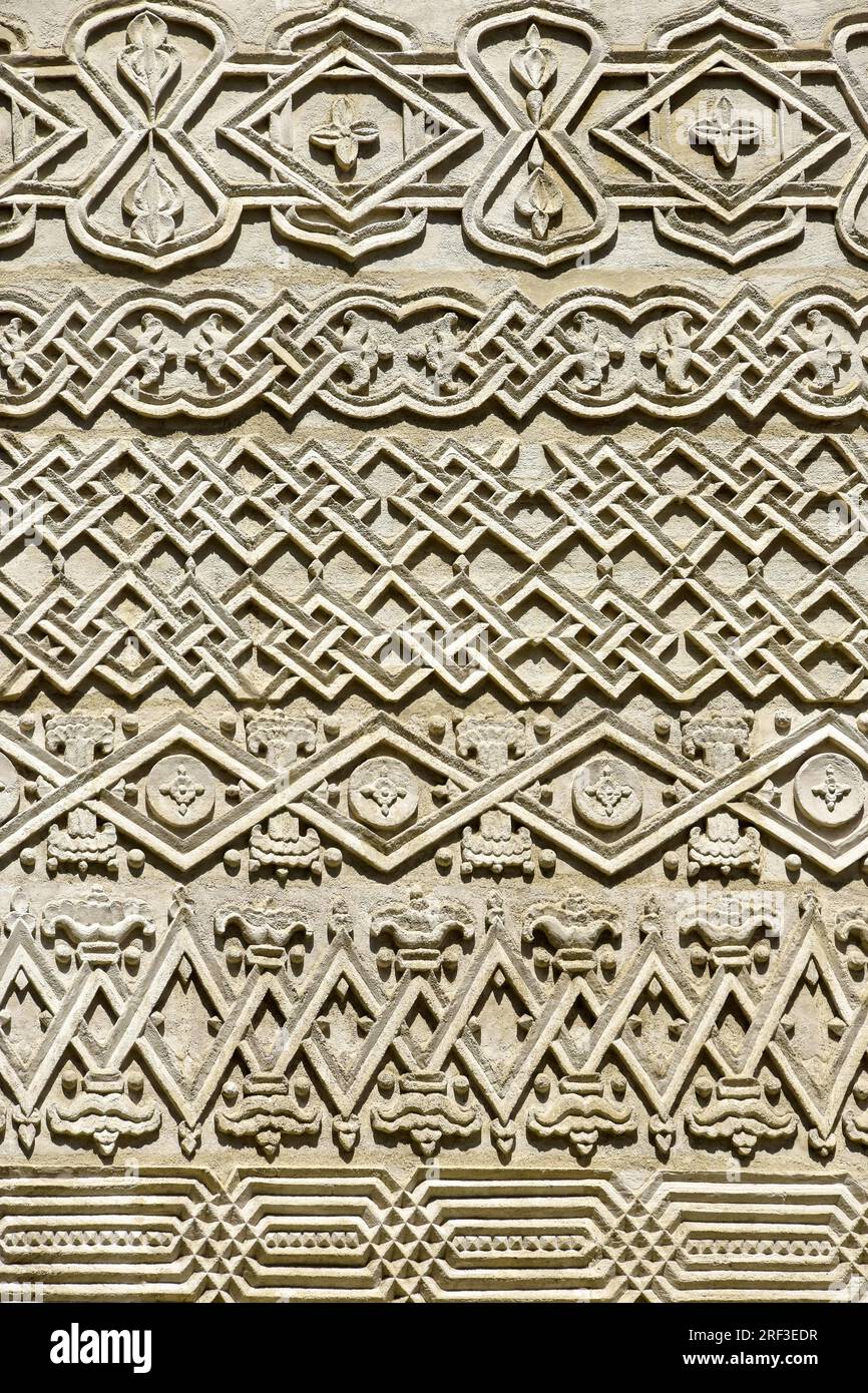 Carved embossed patterns on the stone wall of an ancient church ...