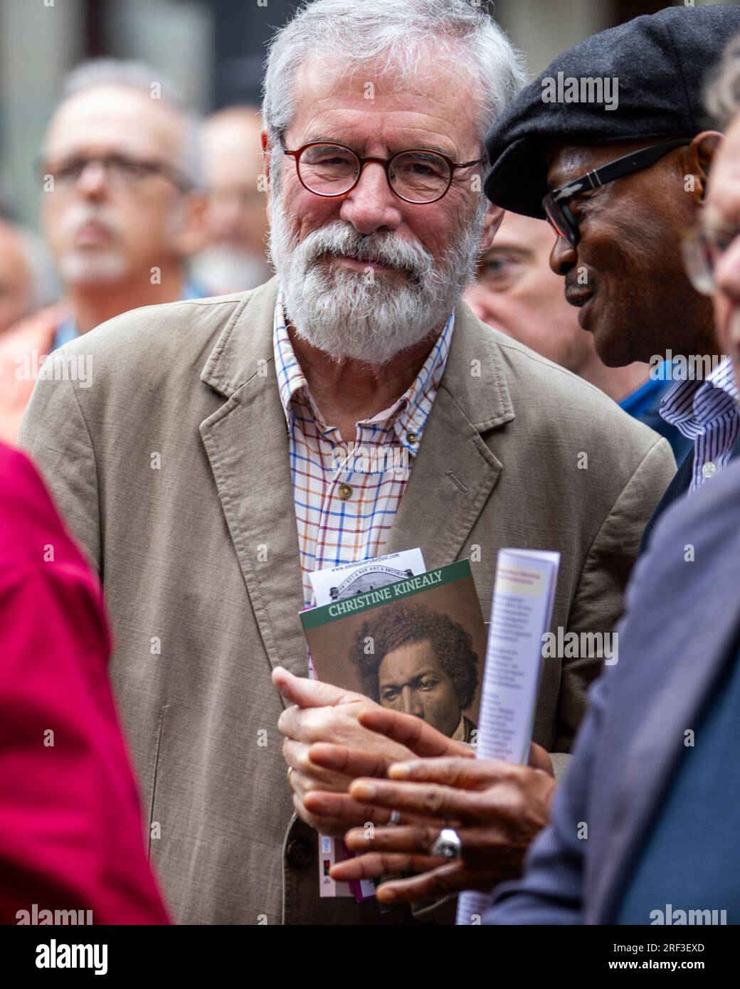 A man speaks with former Sinn Fein president Gerry Adams (left) during ...