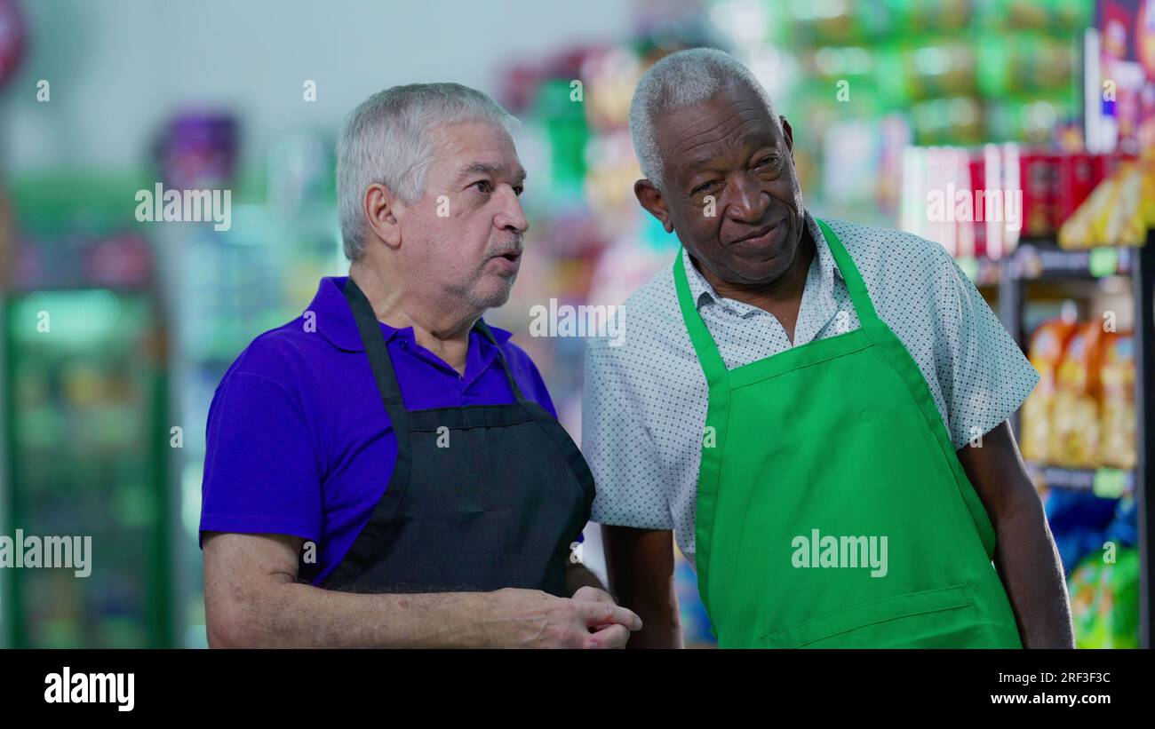 Senior diverse employees of grocery store discussing management of ...