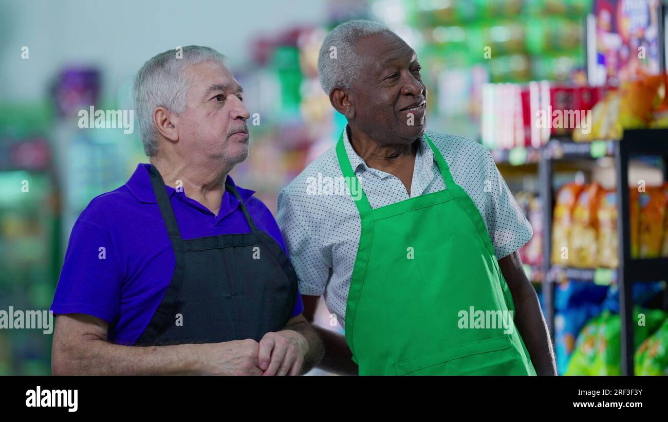 Senior diverse employees of grocery store discussing management of ...