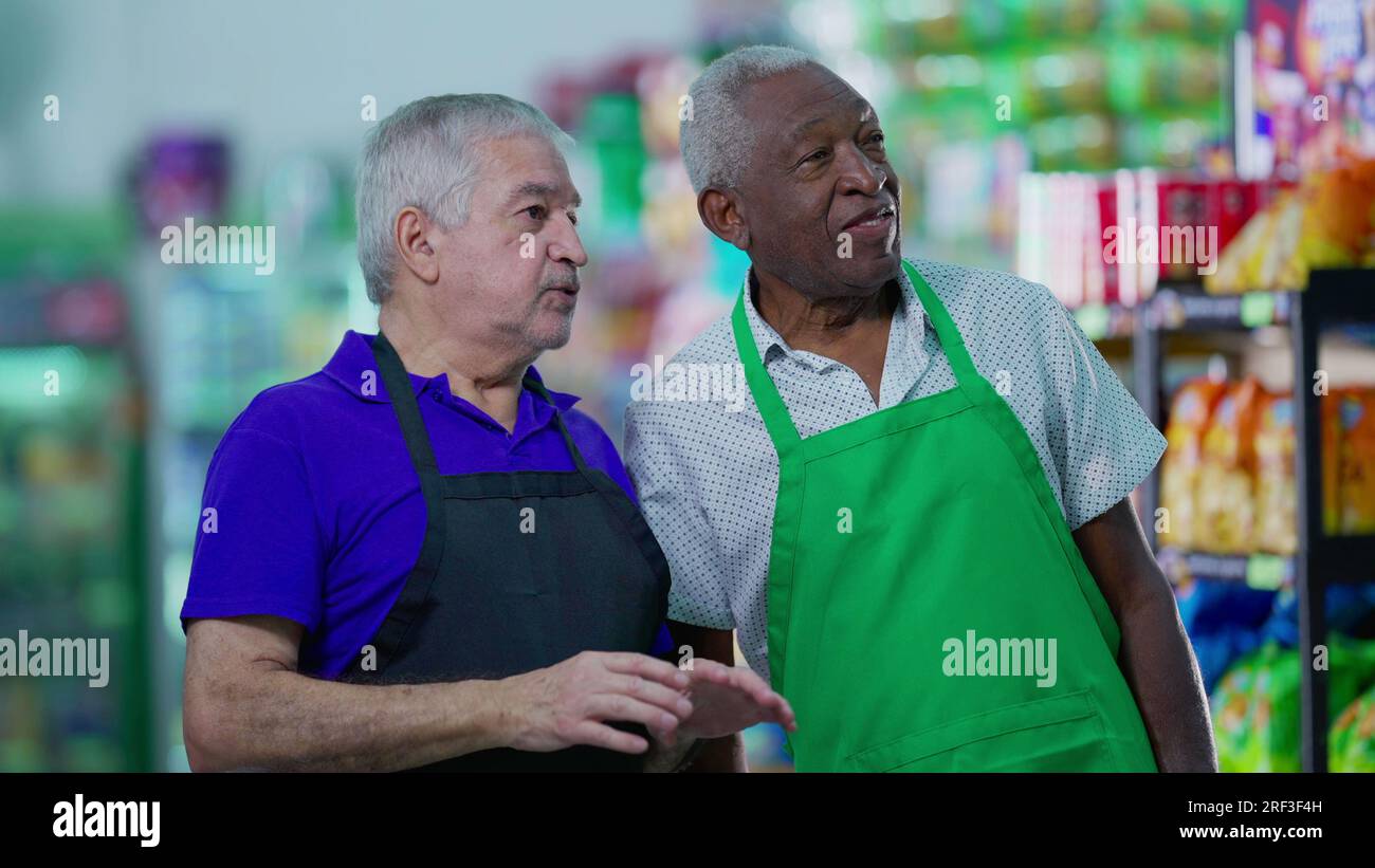 Senior diverse employees of grocery store discussing management of ...