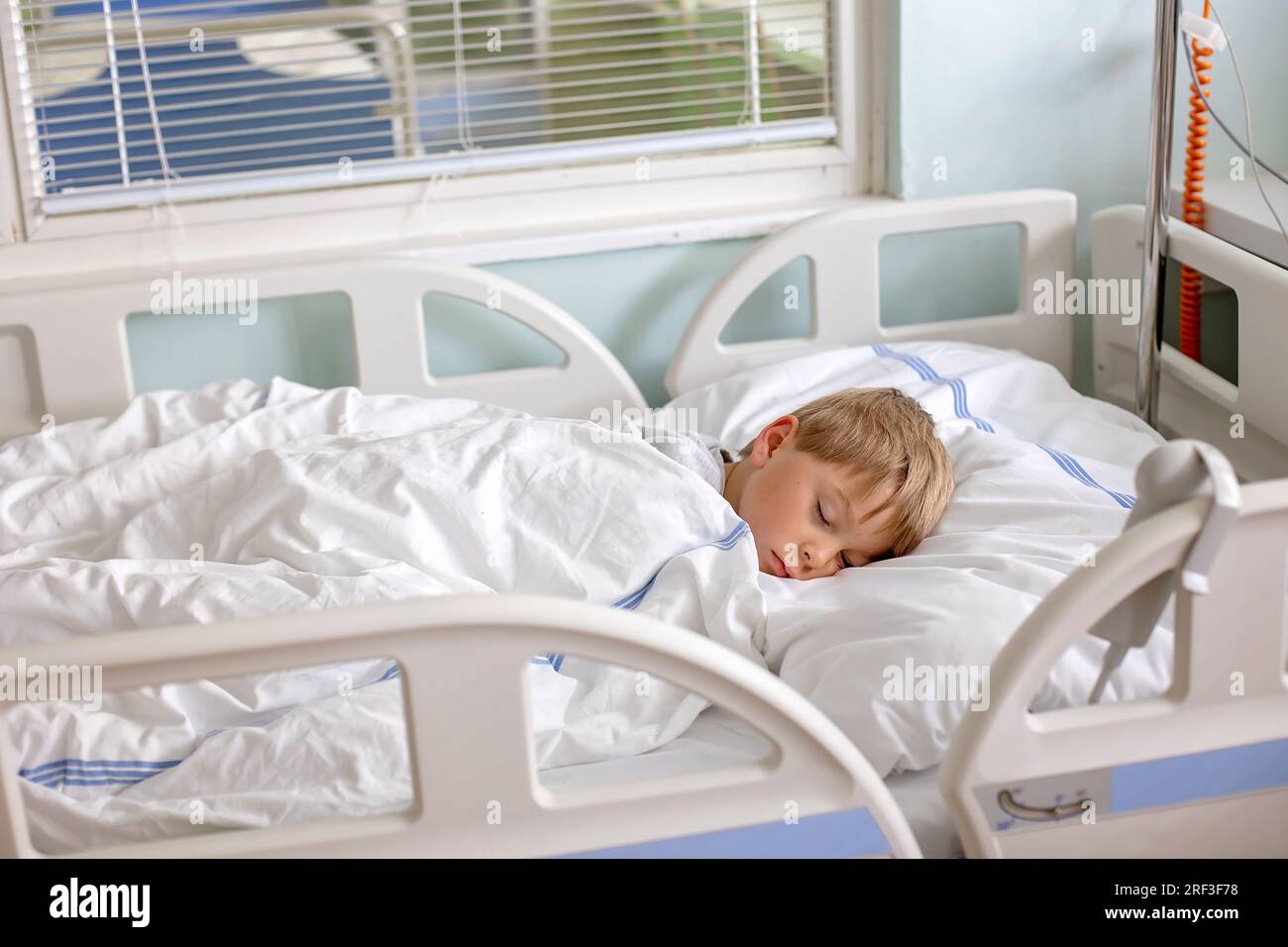 Little preschool child, lying in hospital after accident, mother ...