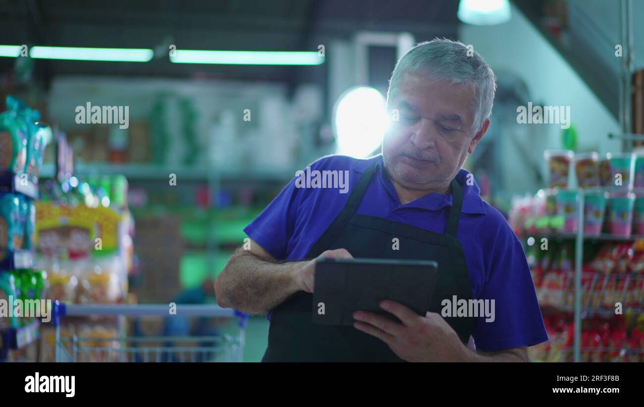 Senior Grocery Store Manager Checking Product Inventory on Shelf with ...