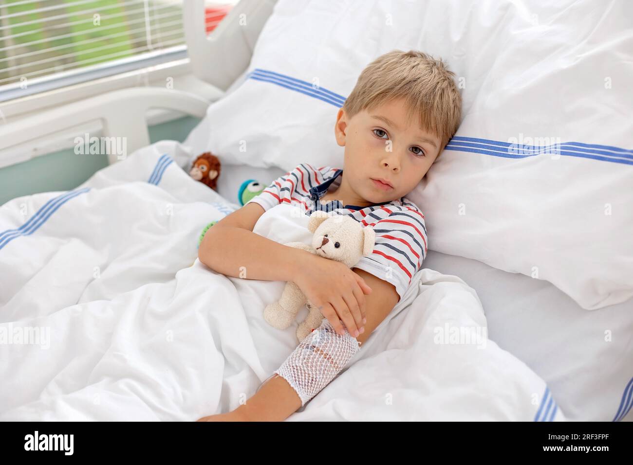 Little preschool child, lying in hospital after accident, mother ...