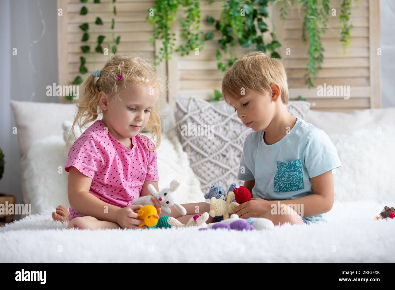 Cute sweet toddler children, tickling feet on the bed, laughing and ...