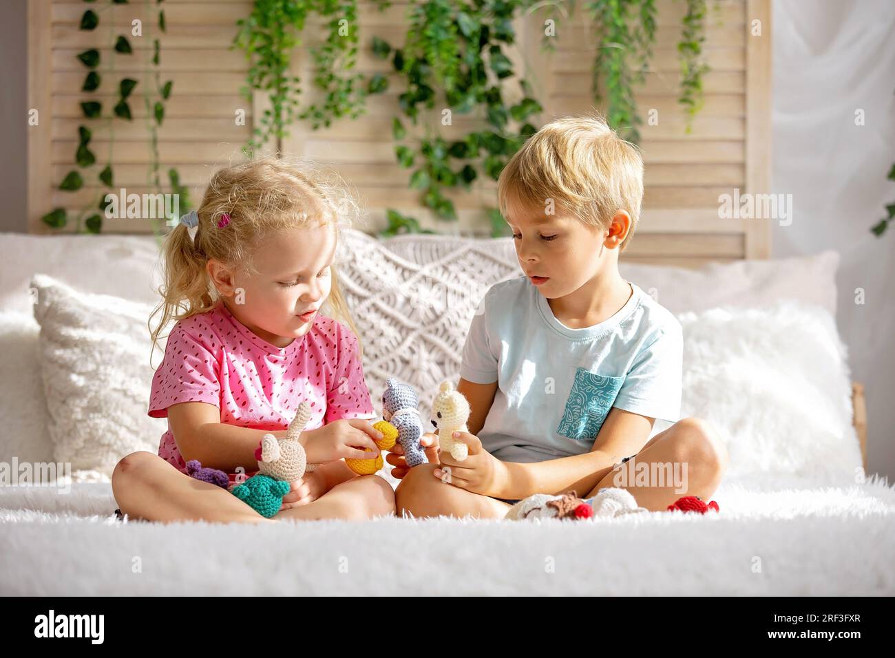 Cute sweet toddler children, tickling feet on the bed, laughing and ...