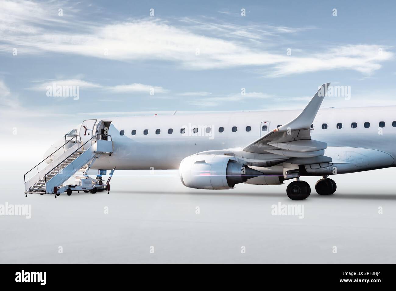 White passenger jet plane with boarding steps isolated on bright ...
