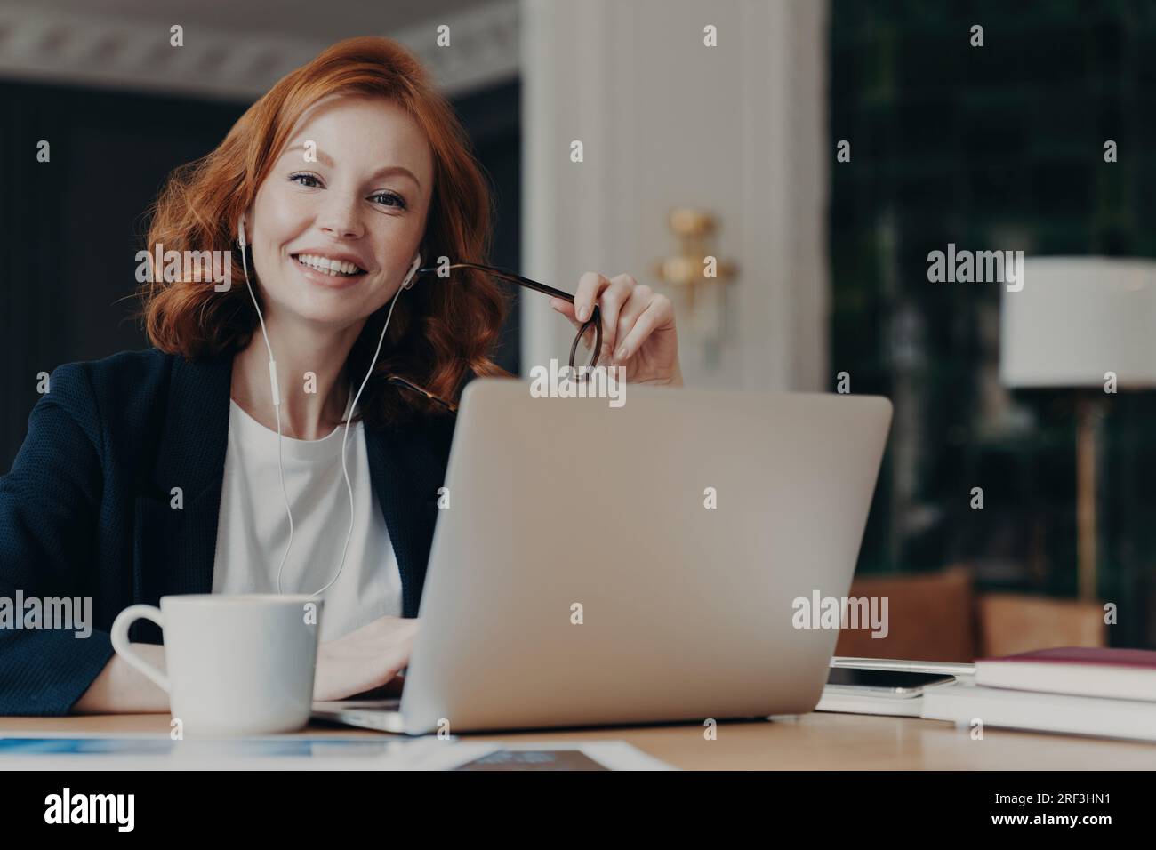 Ginger freelancer, remote work, laptop, ideas, video call, earphones ...