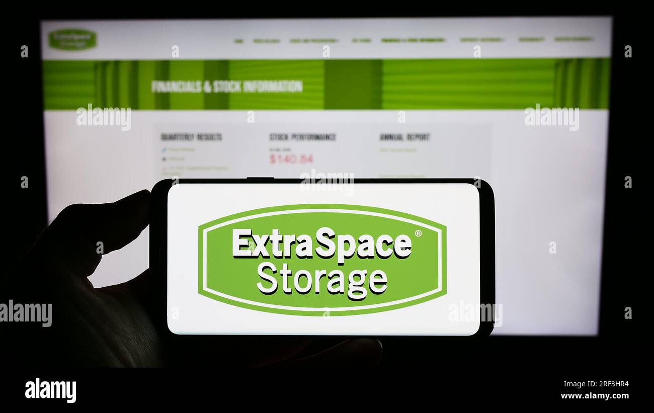 Person holding mobile phone with logo of American company Extra Space ...