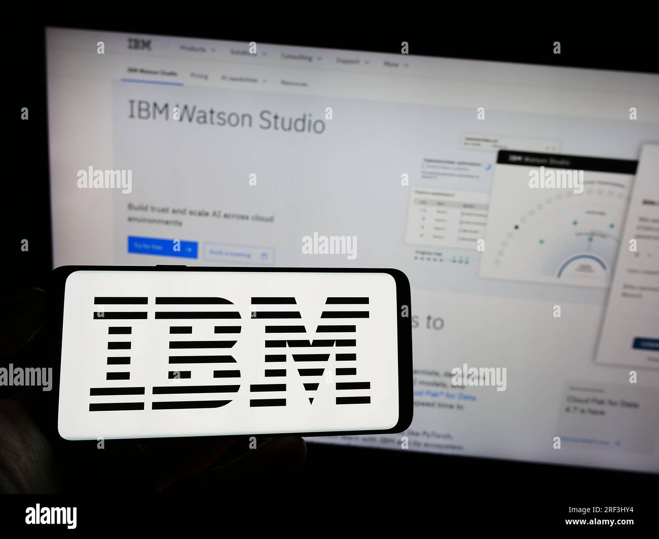 Person holding mobile phone with logo of International Business ...